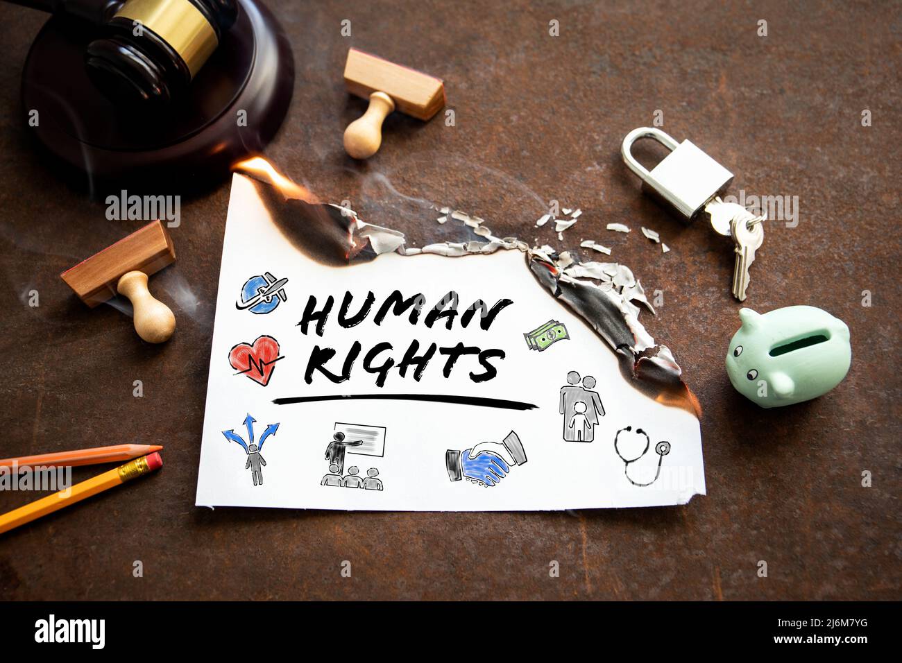 HUMAN RIGHTS. Judge's hammer and office supplies on a rusty metal ...