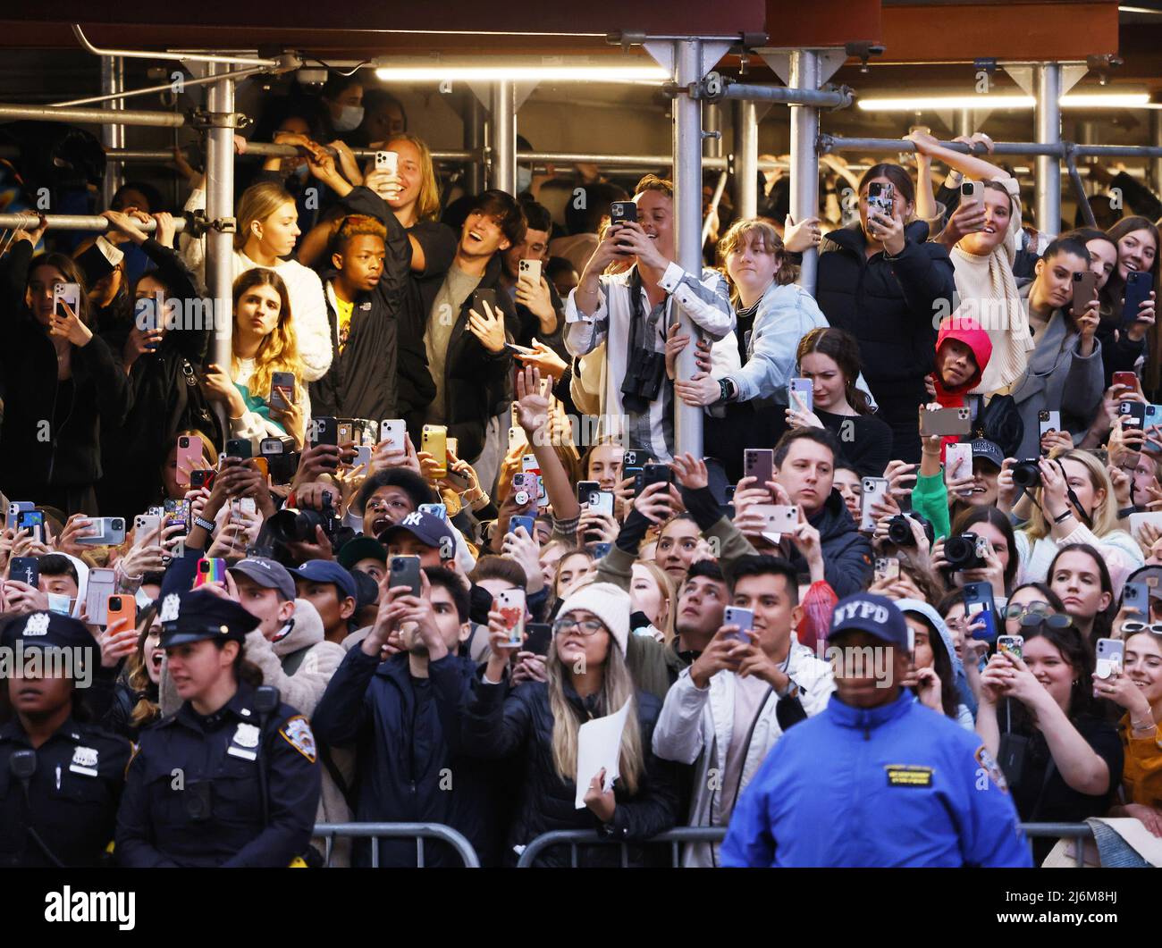 Crowds gather on the sidewalks to watch celebrities arrive on the red ...