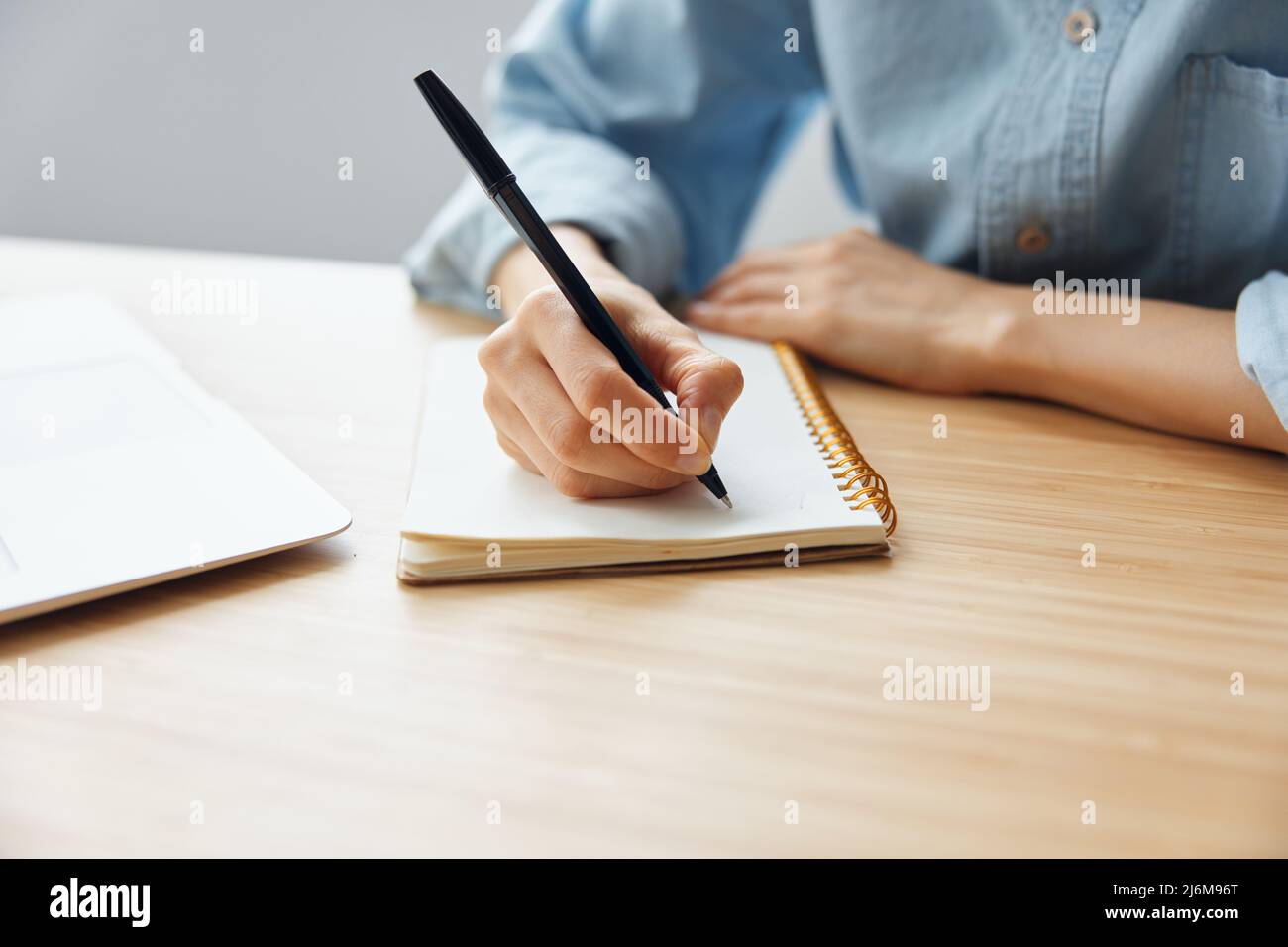 Closeup shot of woman's hand writing to do list future plans for work ...