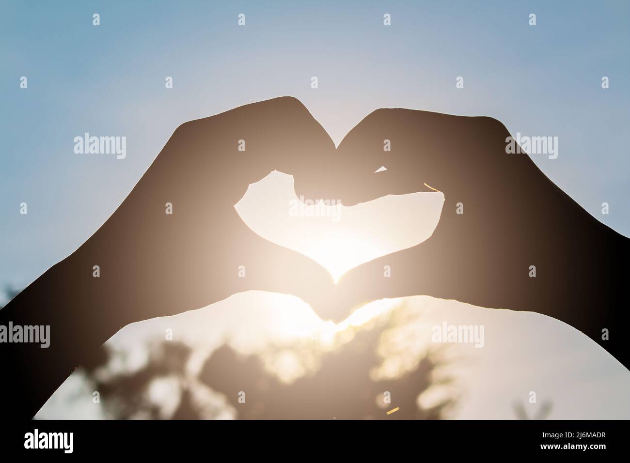 love shape hand silhouette at sunset background Stock Photo - Alamy