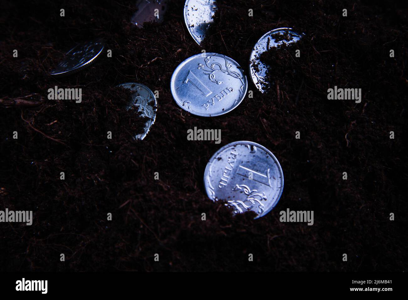 Coin in the ground. Money scattered on the ground. The depreciation of ...