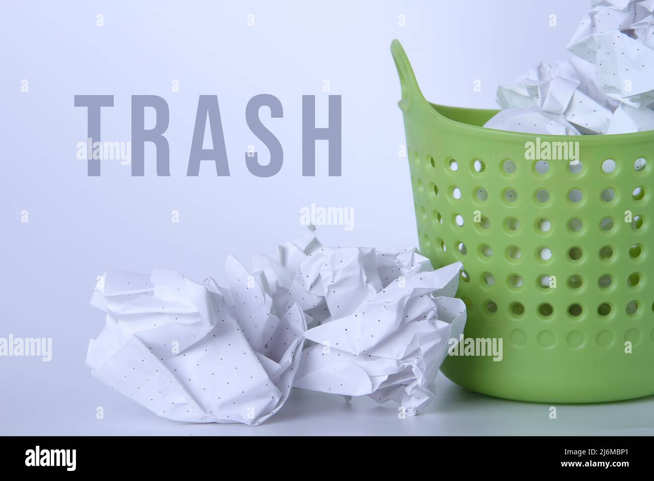 Green trash can. Full basket. Crumpled paper in a basket. A mountain of ...