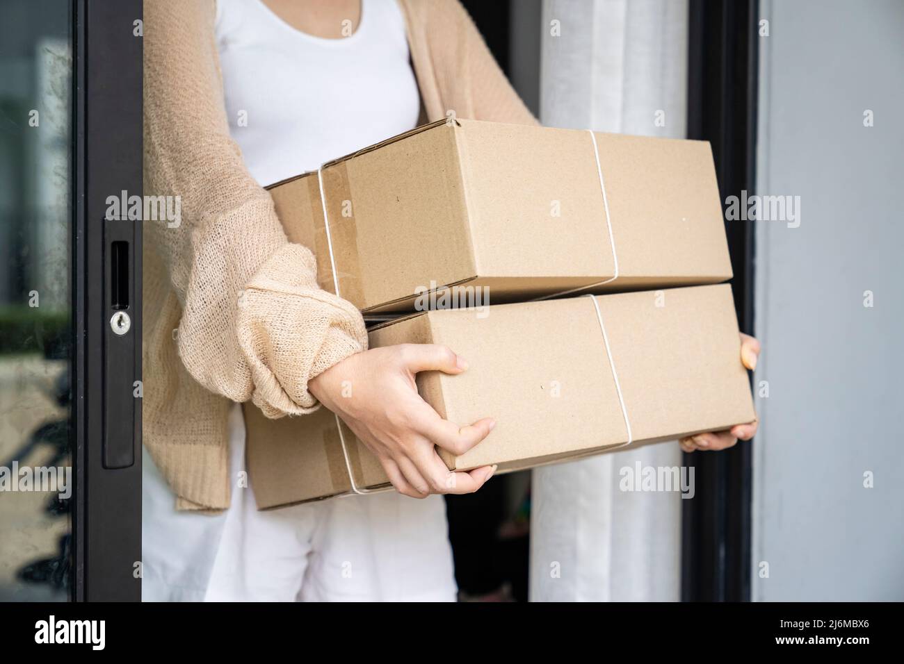 Woman receiving parcel at the door, Delivery online order to home Stock ...