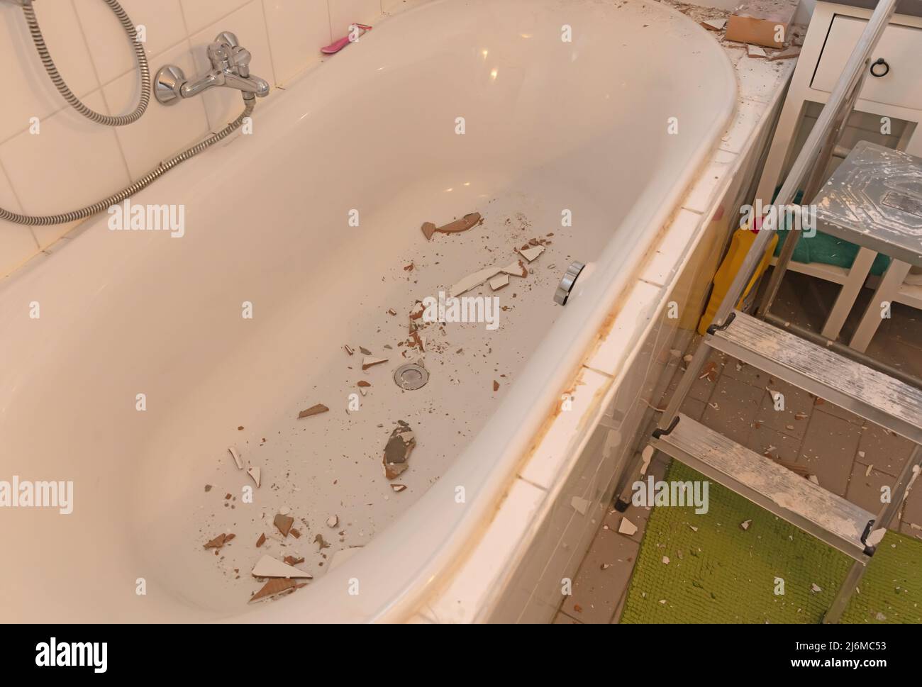 Breaking ceramic tiles, work in progress, maintenance Stock Photo - Alamy
