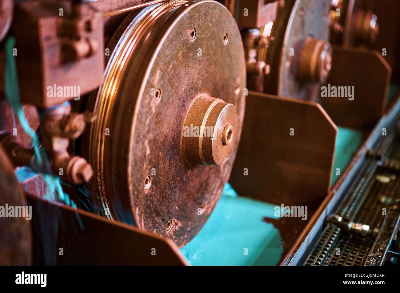 Copper wire straightener machine tool in plant workshop Stock Photo - Alamy