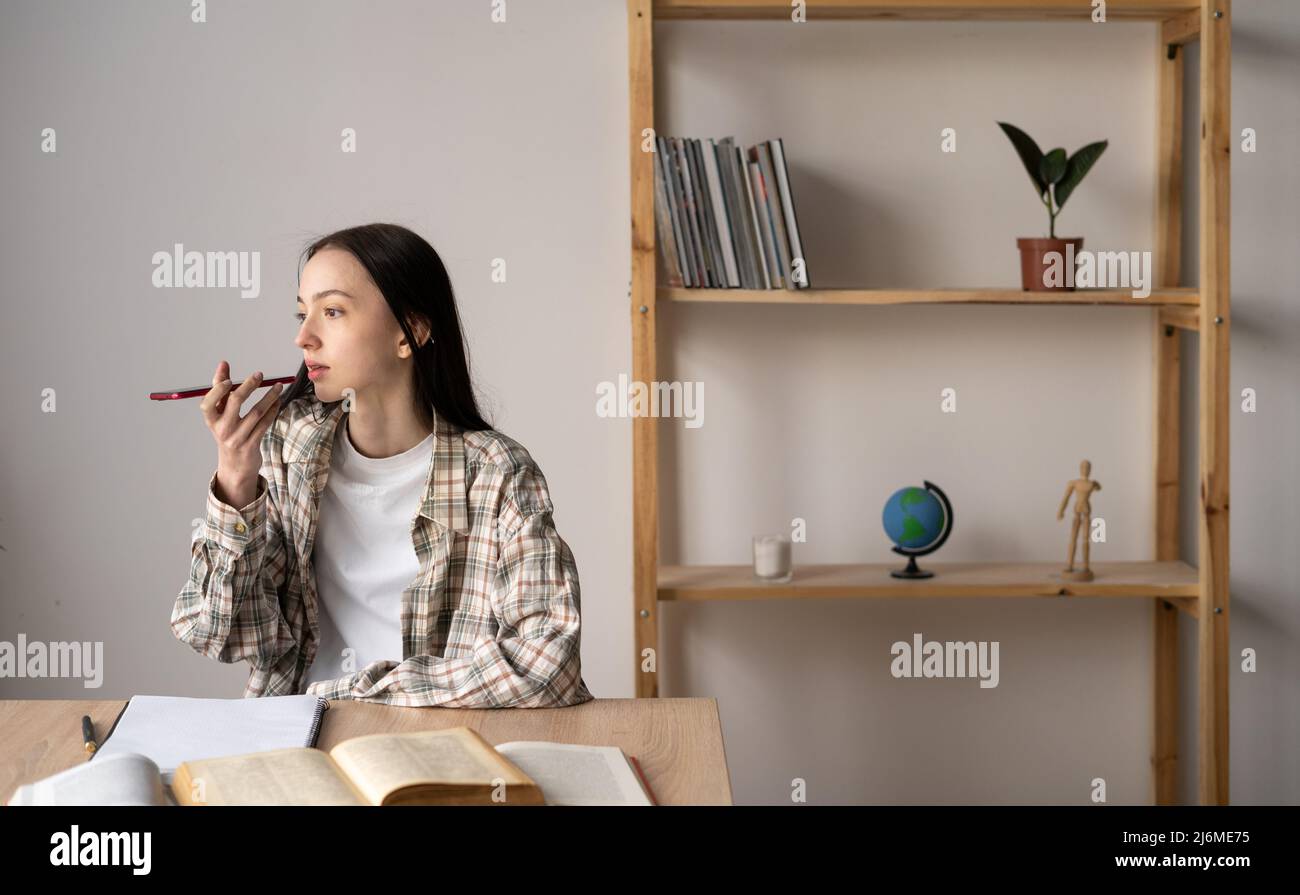 Caucasian girl student using virtual assistant recording audio message ...