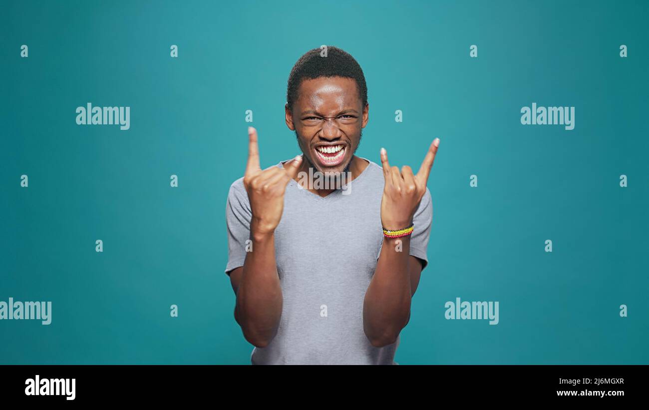Gesturing devil horns hi-res stock photography and images - Alamy