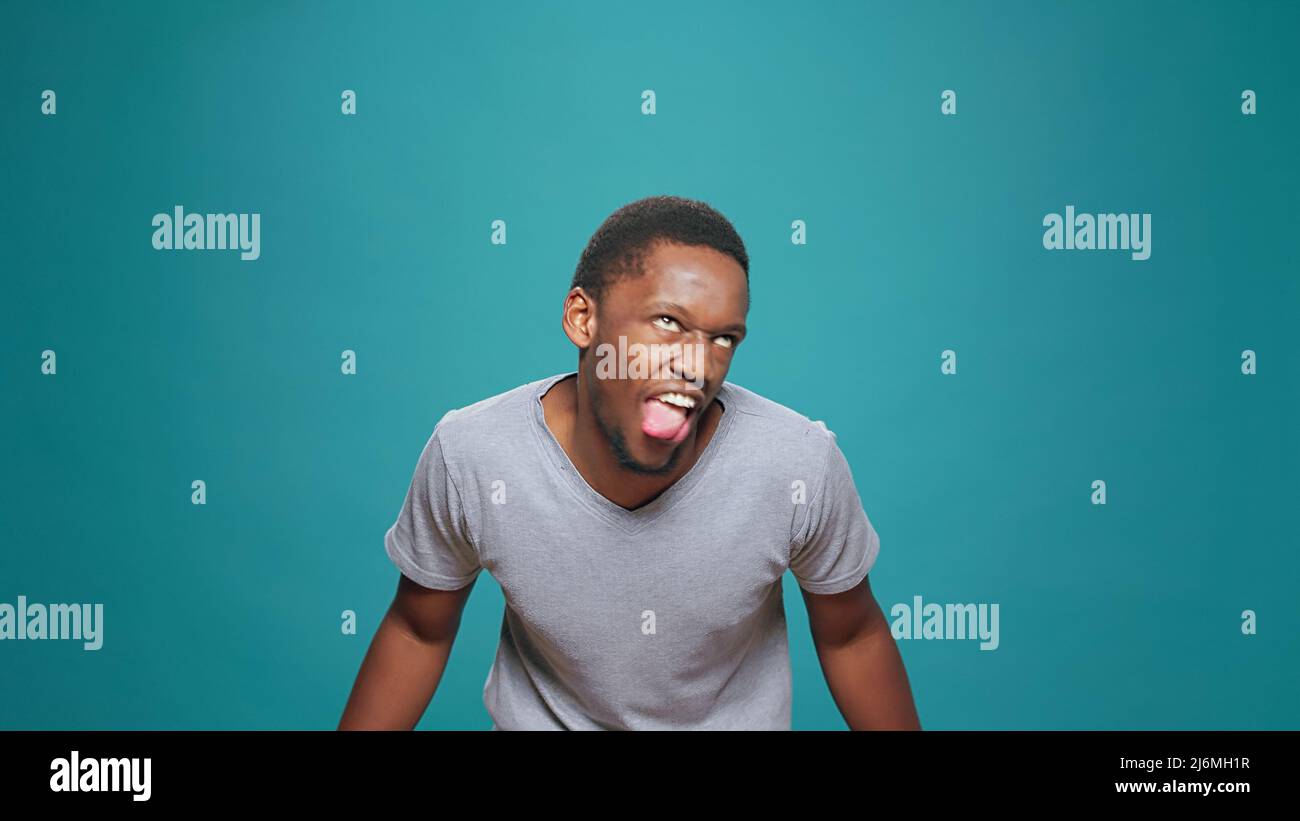 Silly goofy man fooling around and sticking tongue out on camera ...