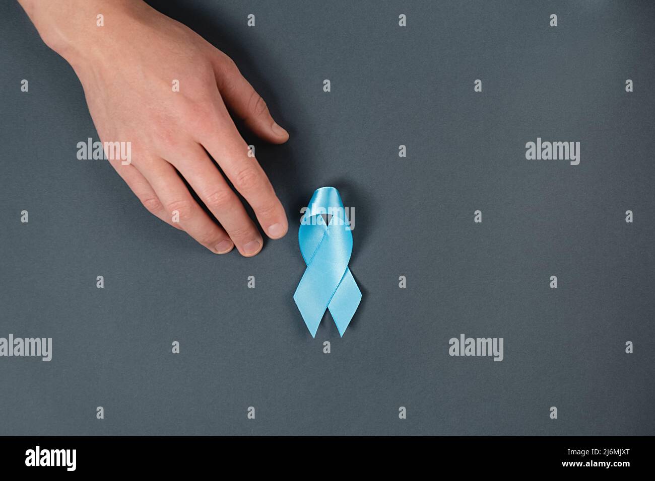 Symbol for support men. Male hand and blue ribbon on grey background ...