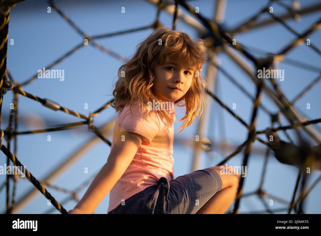 Children playground in urban park. Child climbing the net. Kids play ...