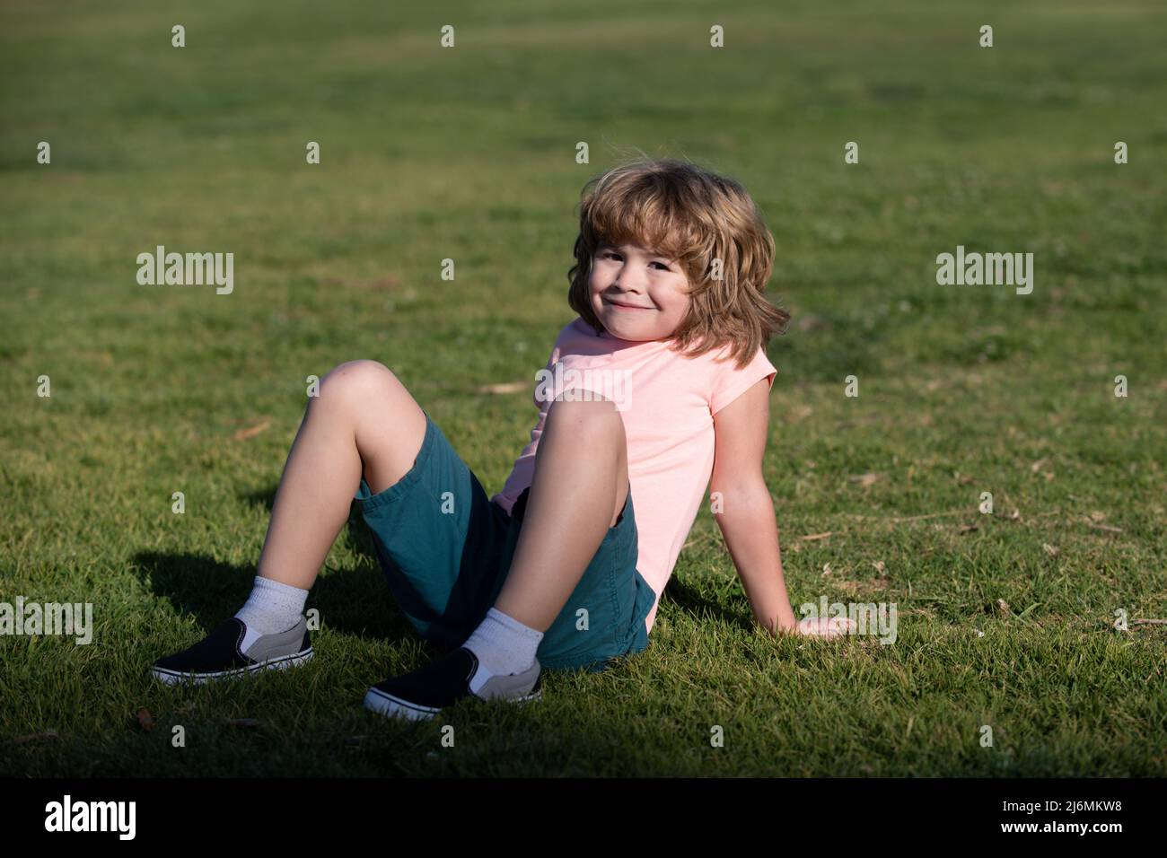 Summer kids outdoor. Happy child enjoying summer. Kids on green grass ...