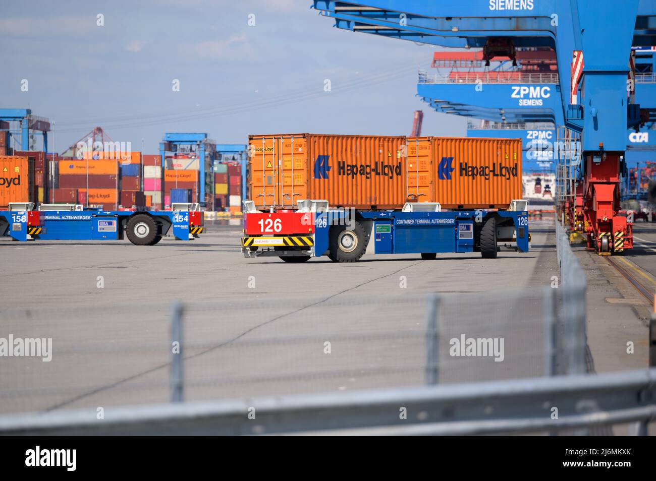 27 April 2022, Hamburg: Containers labeled "Hapag-Lloyd" are loaded by ...