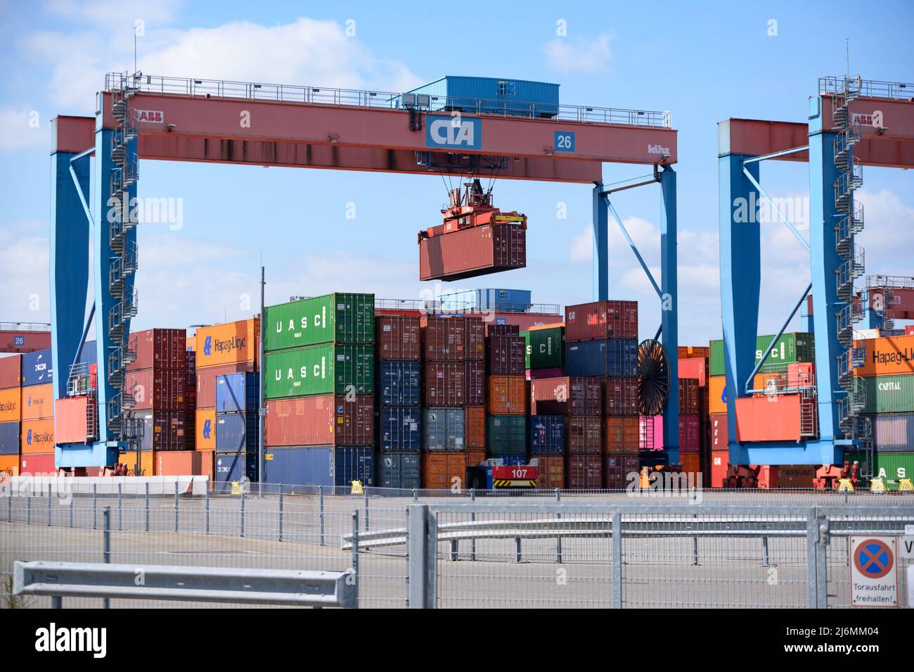 27 April 2022, Hamburg: A container is loaded on the premises of HHLA ...