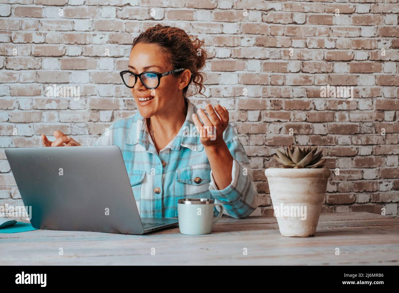 Adult talking laptop home desk hi-res stock photography and images - Alamy