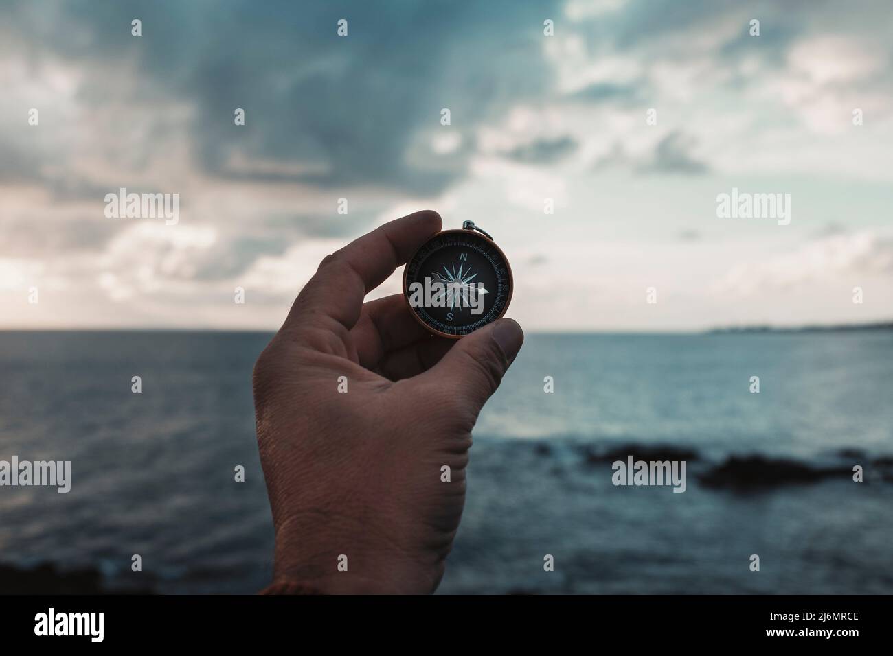 Pov of man hand holding navigational travel compass to find direction ...