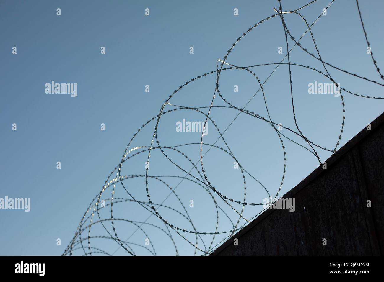 Barbed wire fence. Fence of territory. Concrete obstacle. Wall of ...