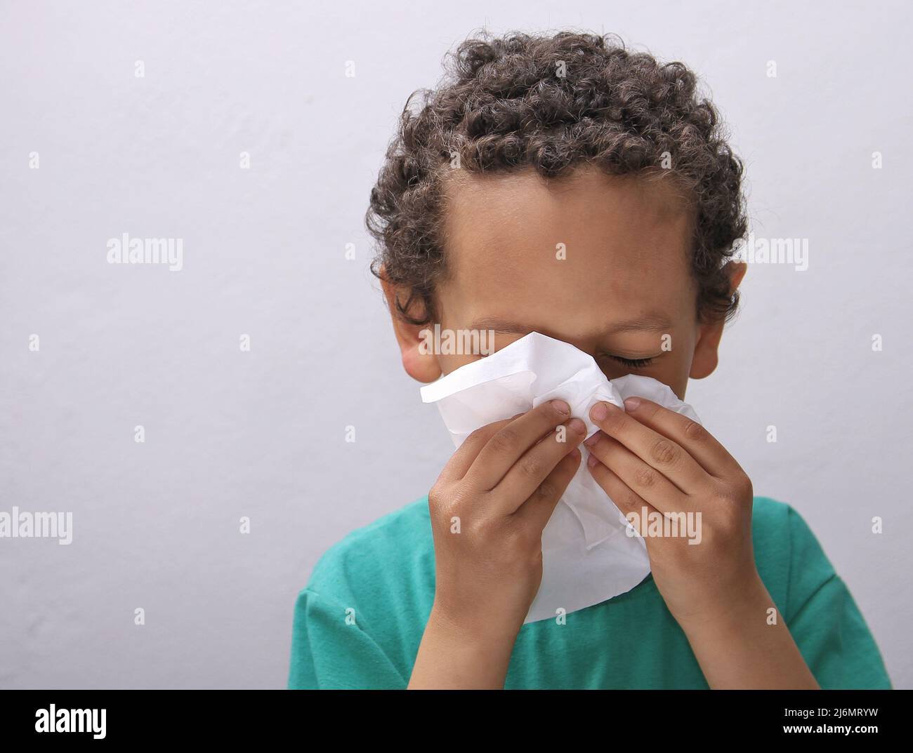 catching the flu child blowing nose after catching a cold with grey ...