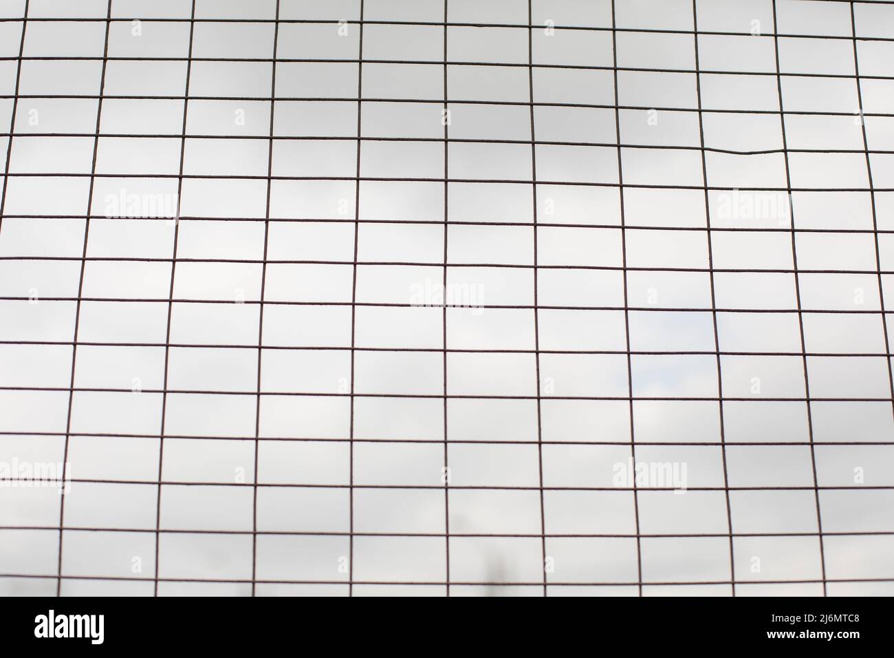 Lattice against gray sky. Steel cage. Texture of straight lines Stock ...