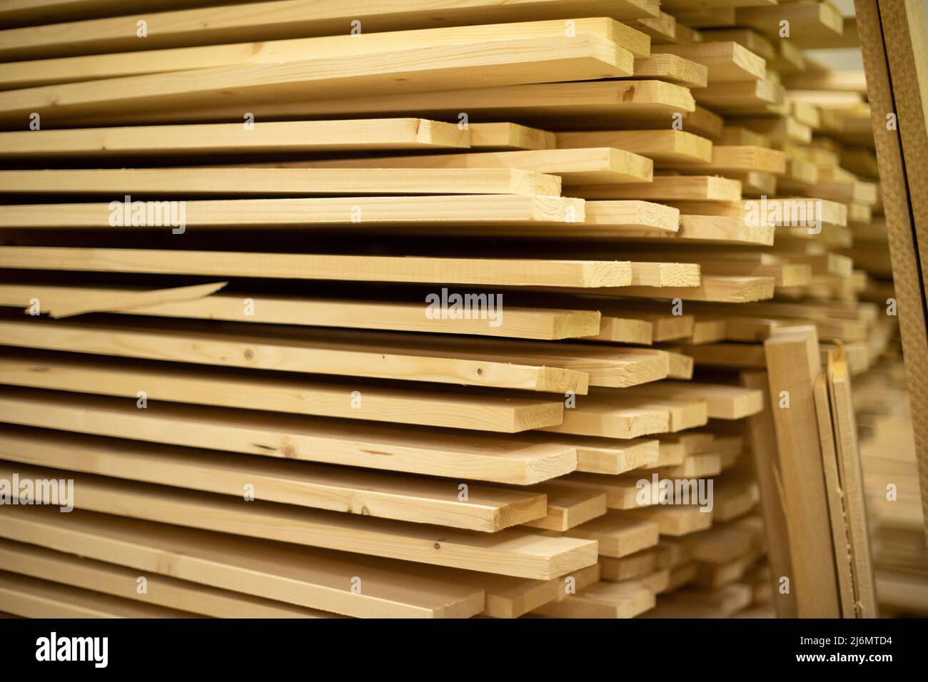 Lot of boards in carpentry workshop. Boards are stacked. Details of ...