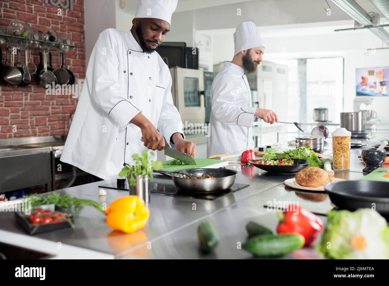 Food industry african american worker chopping fresh organic herbs ...