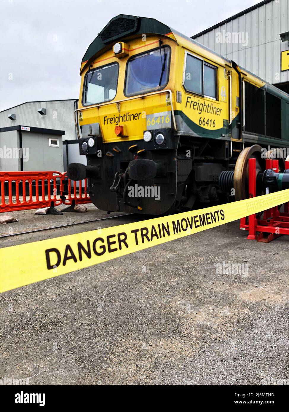 Rail safety danger sign warning railroad workers of moving trains and ...