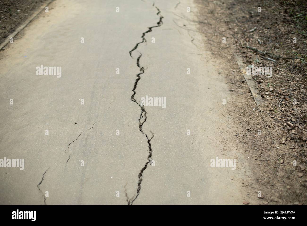 Crack in asphalt. Road with defect. Cracked surface Stock Photo - Alamy