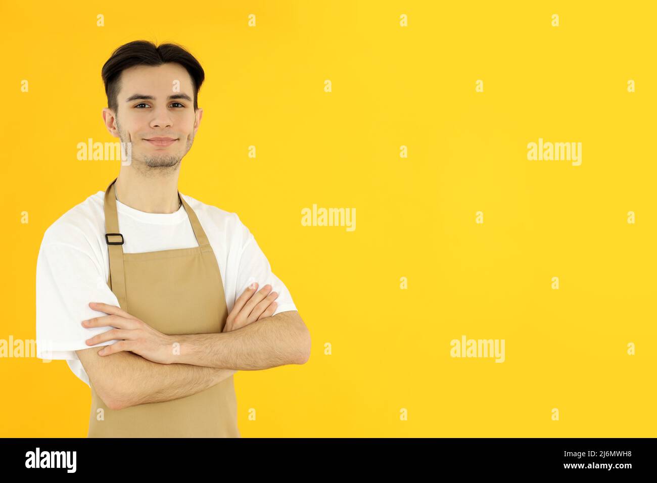 Concept of cooking, young man chef on yellow background Stock Photo - Alamy