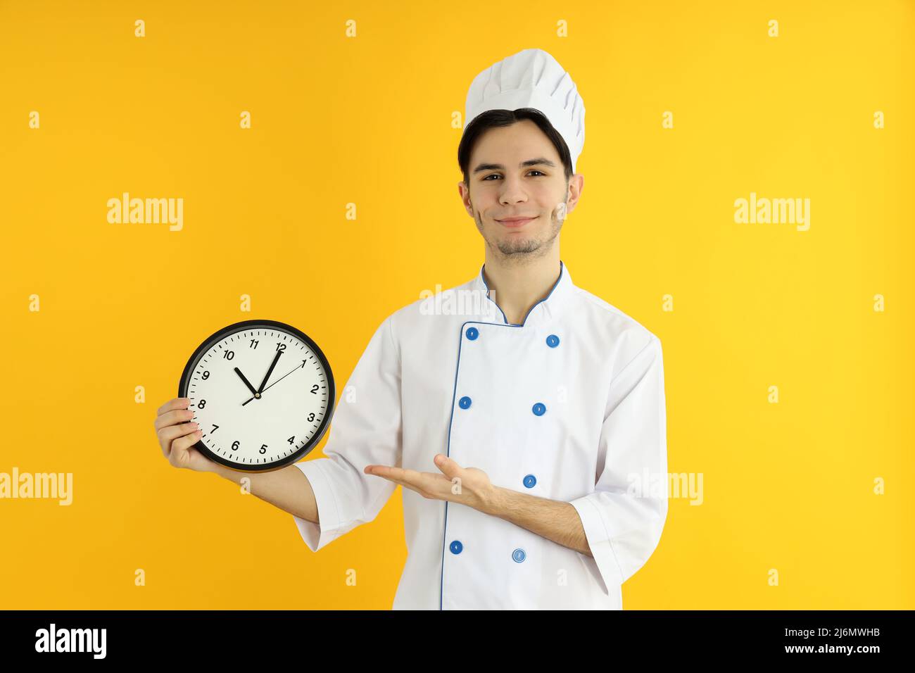 Concept of cooking, young man chef on yellow background Stock Photo - Alamy