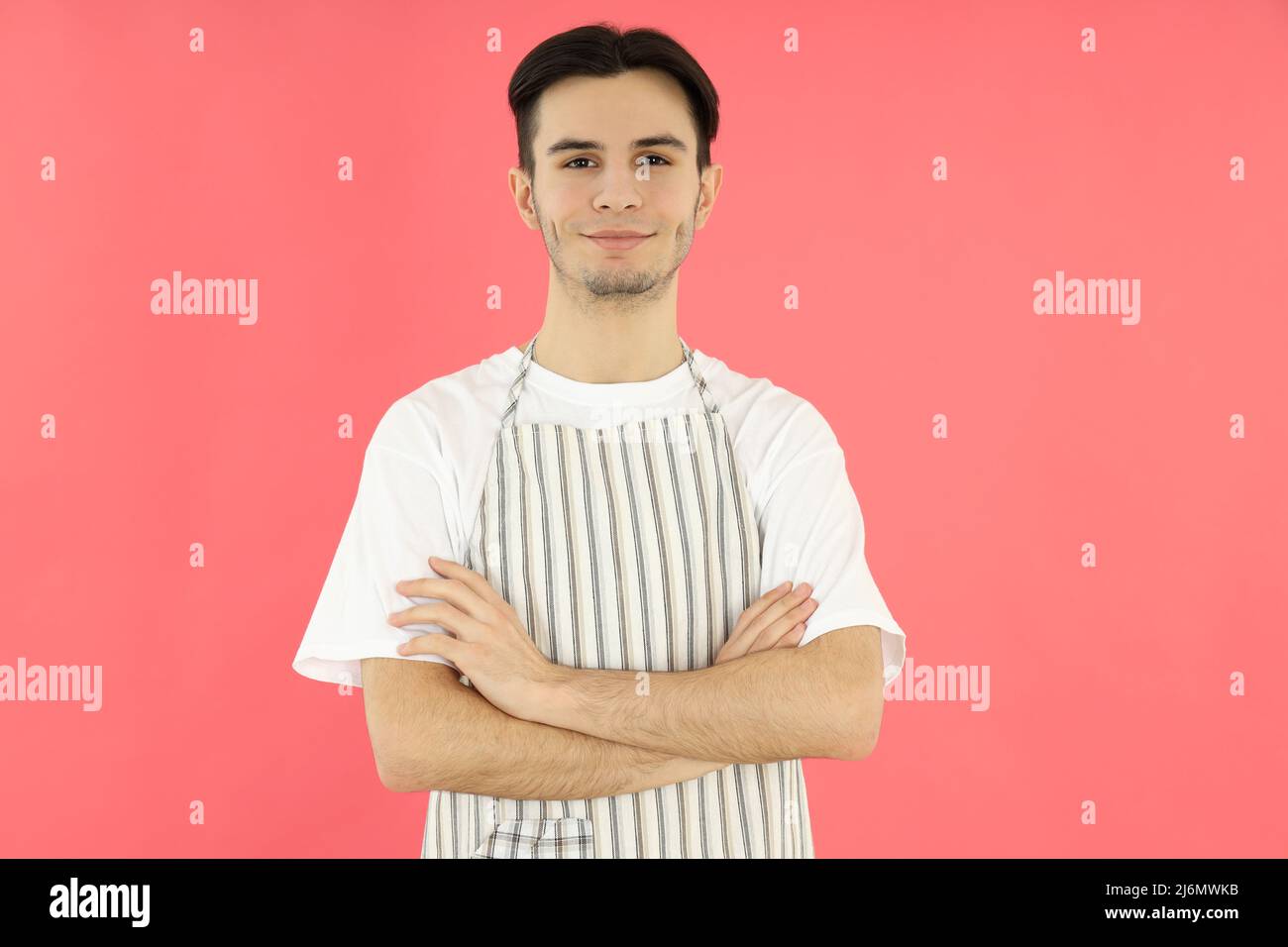 Concept of cooking, young man chef on pink background Stock Photo - Alamy