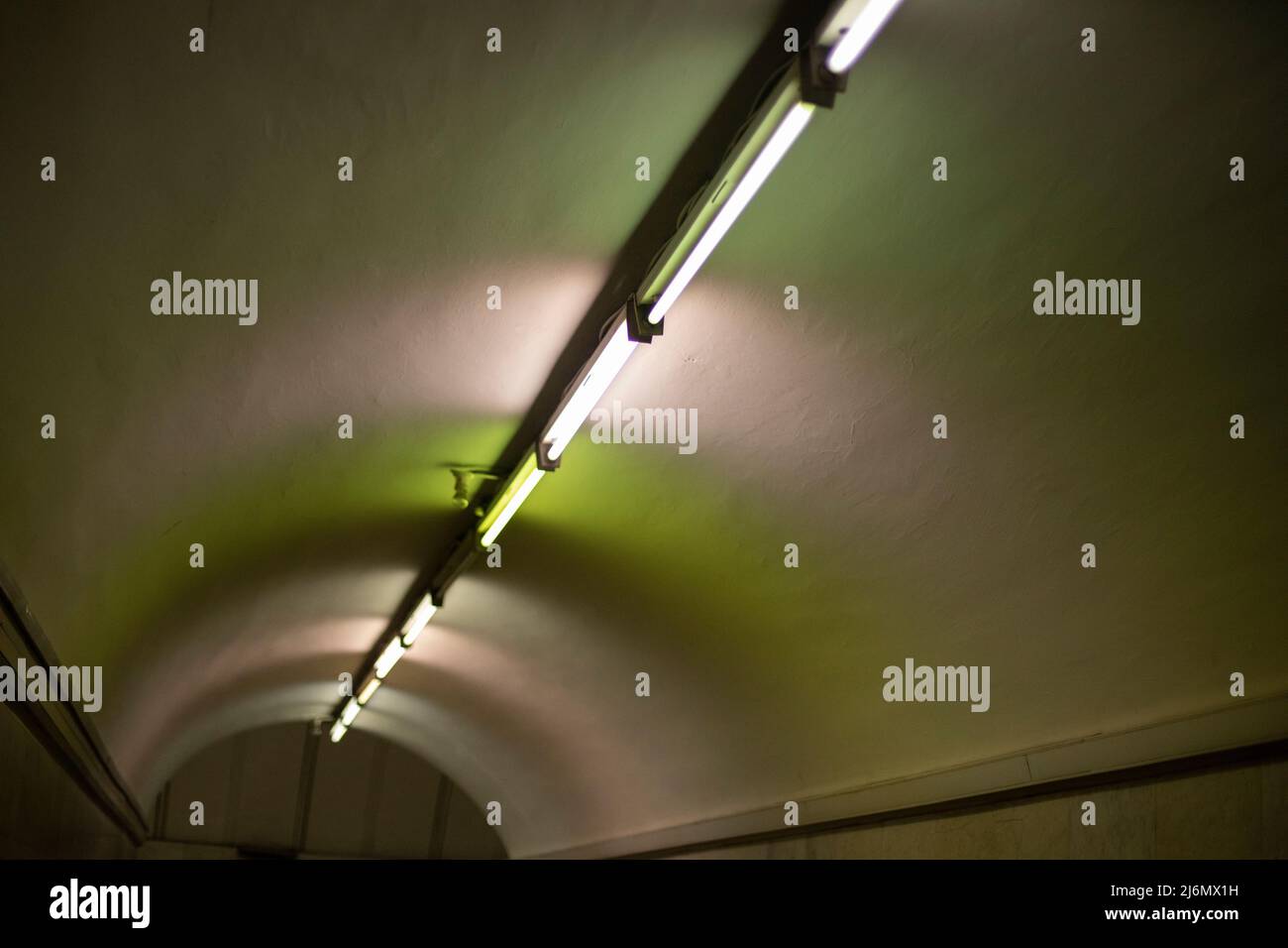 Lamps on ceiling of tunnel. Details of interior of metro. Fluorescent ...