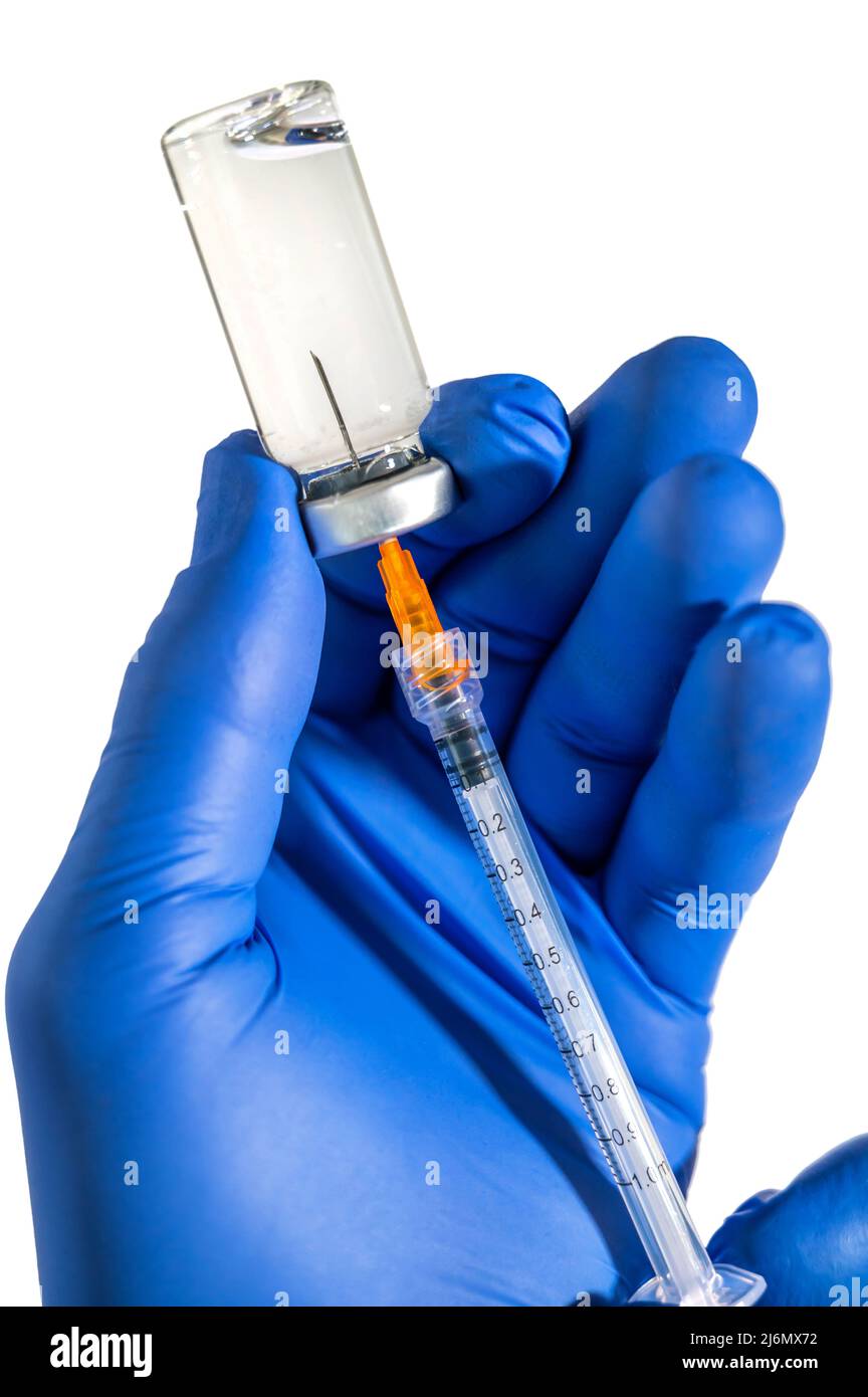 Syringe in an injection jar against white background on the theme of ...