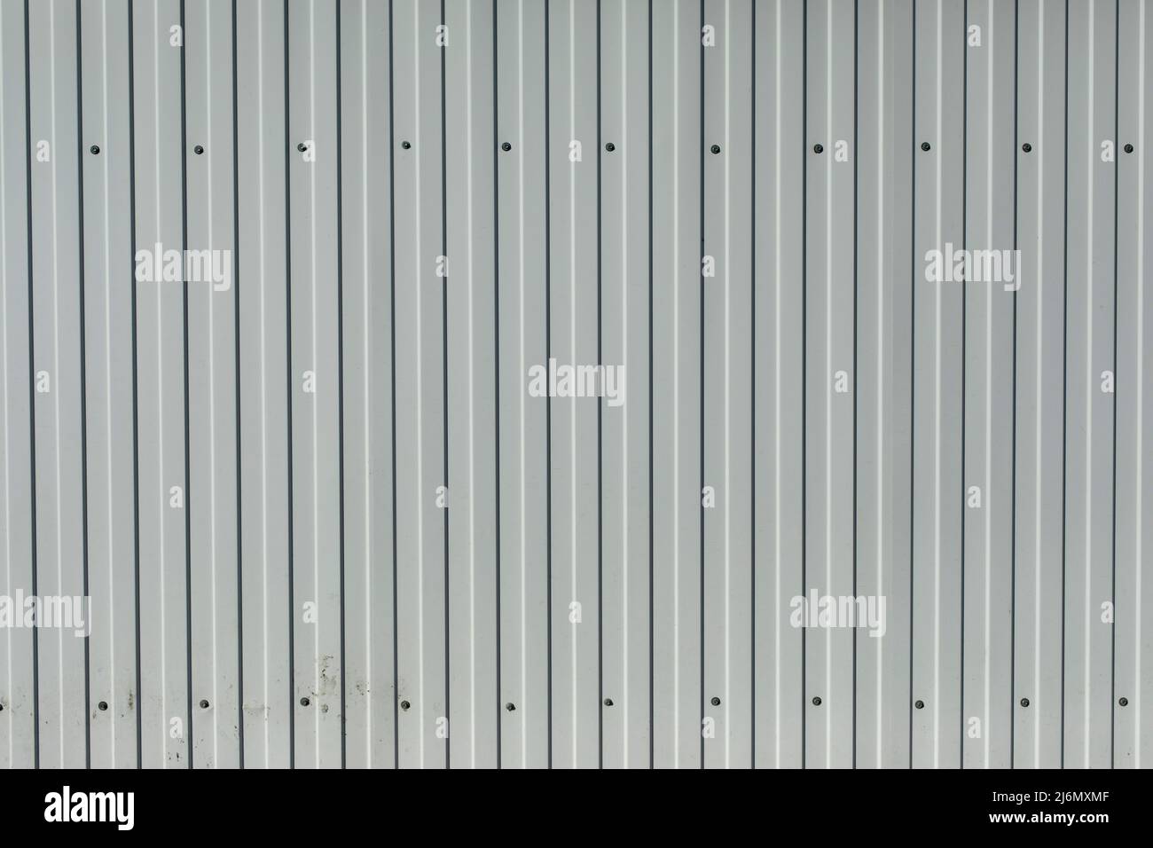 Steel fence. Metal profile sheet of white color. Fence is in detail ...