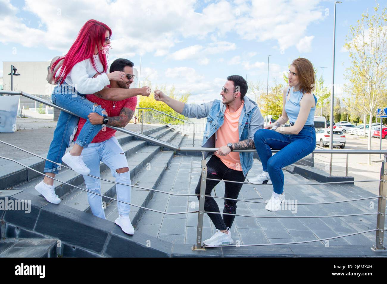 two couples greeting each other in the street Stock Photo - Alamy