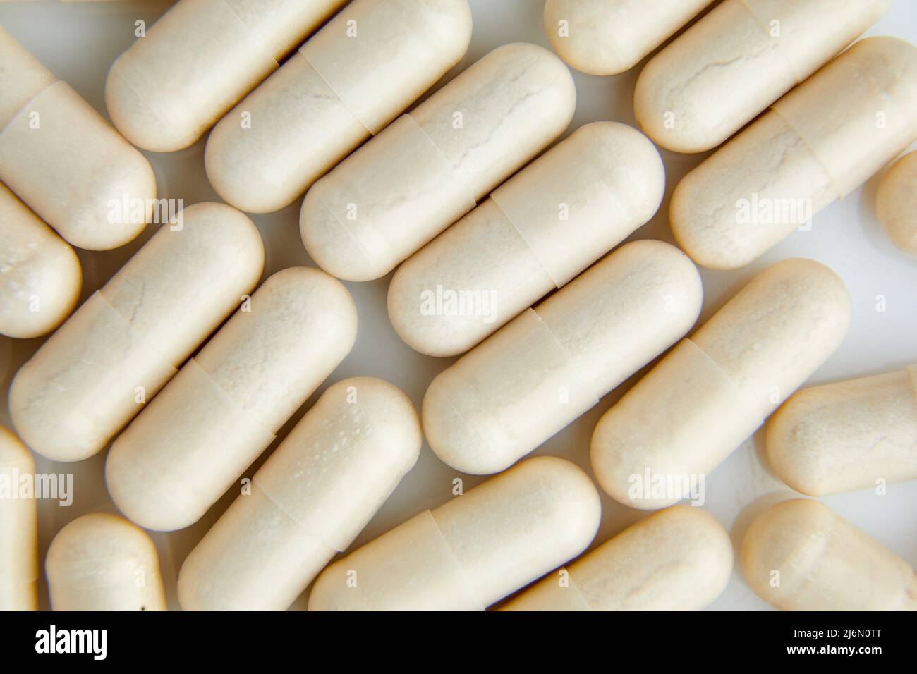 Flat lay macro White beige capsule pills, tablets, top view, close up ...