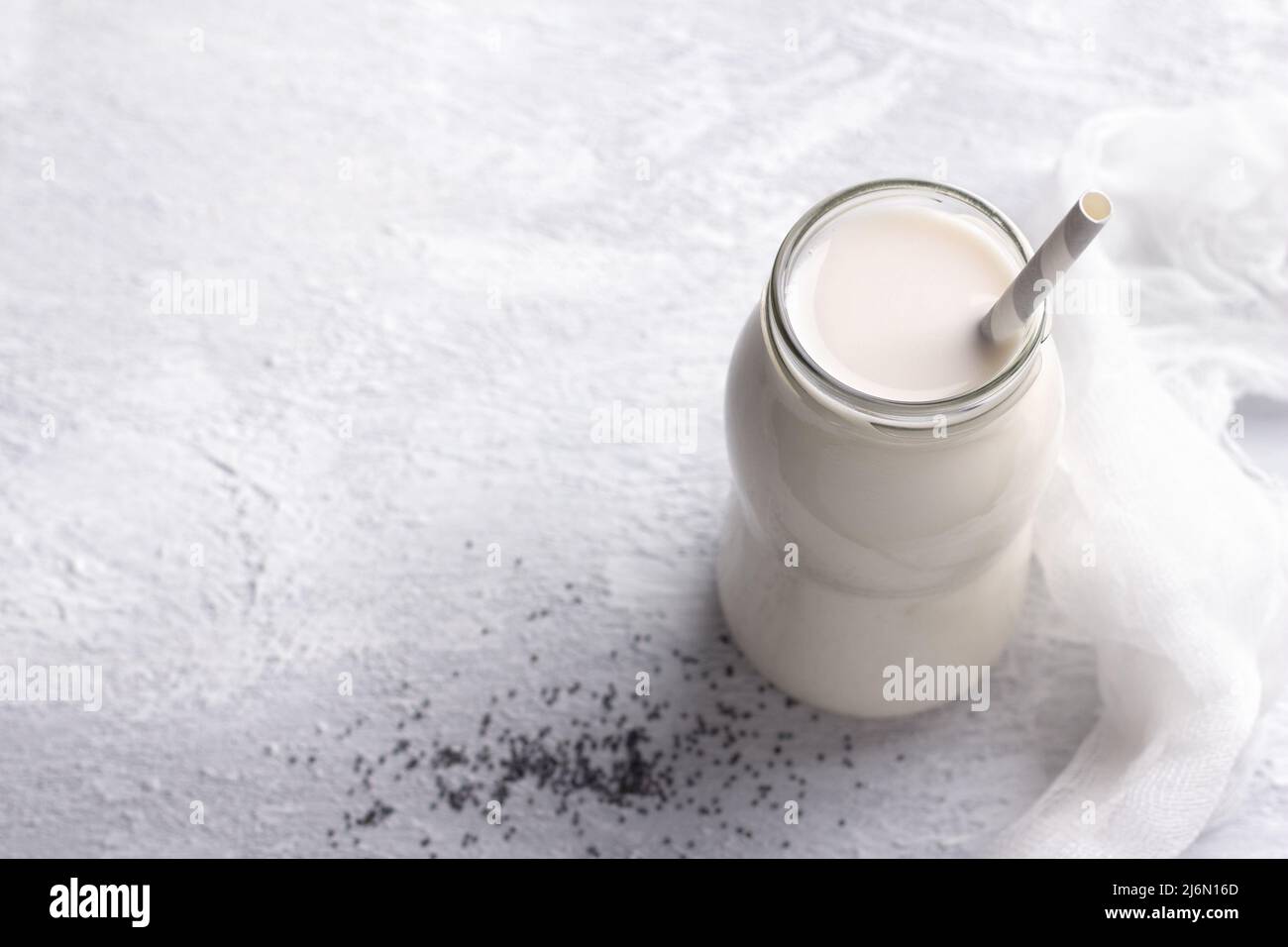 Fresh poppy milk in bottle with seeds on light background. healthy diet ...