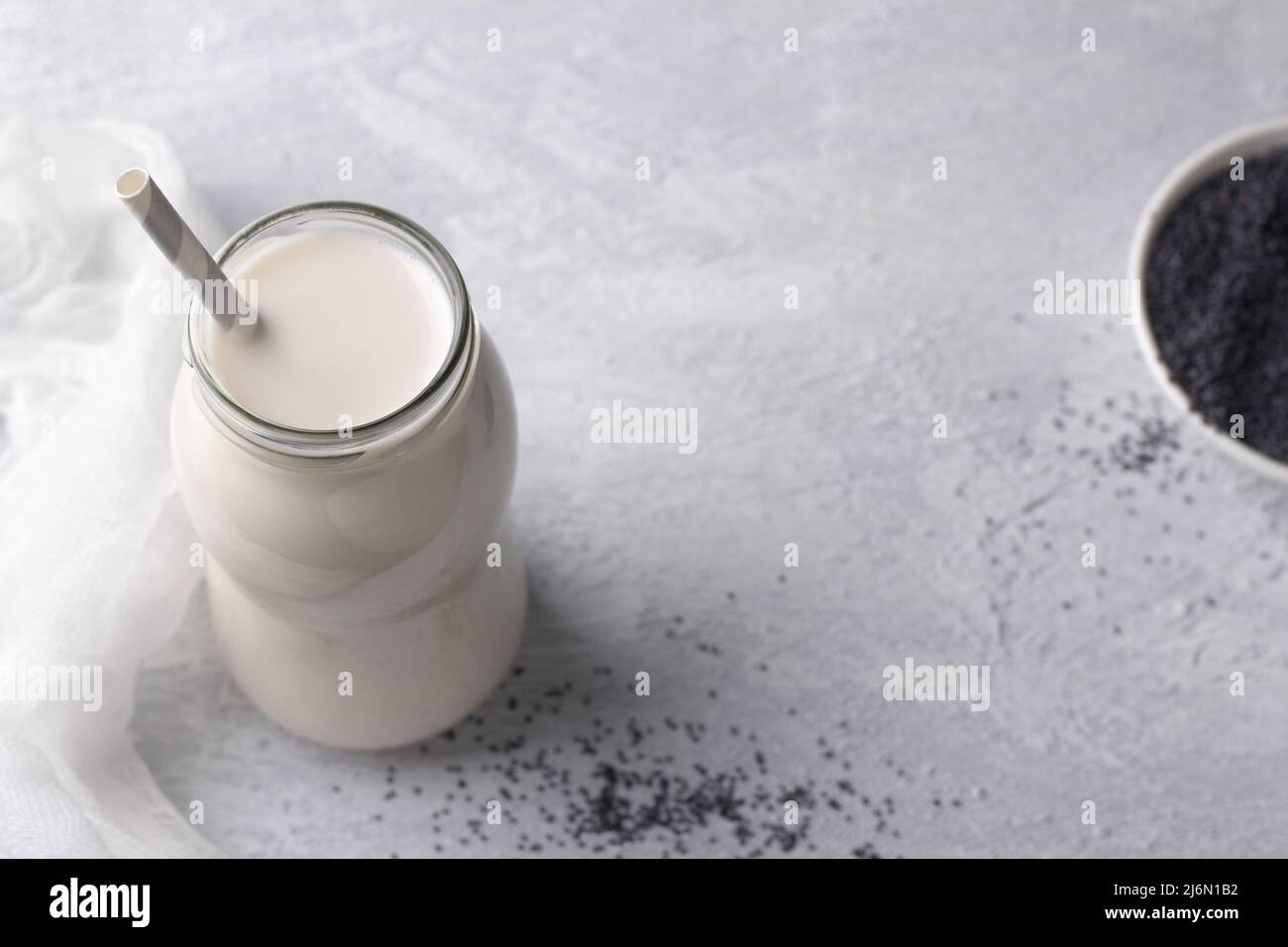 Fresh poppy milk in bottle with seeds on light background. healthy diet ...