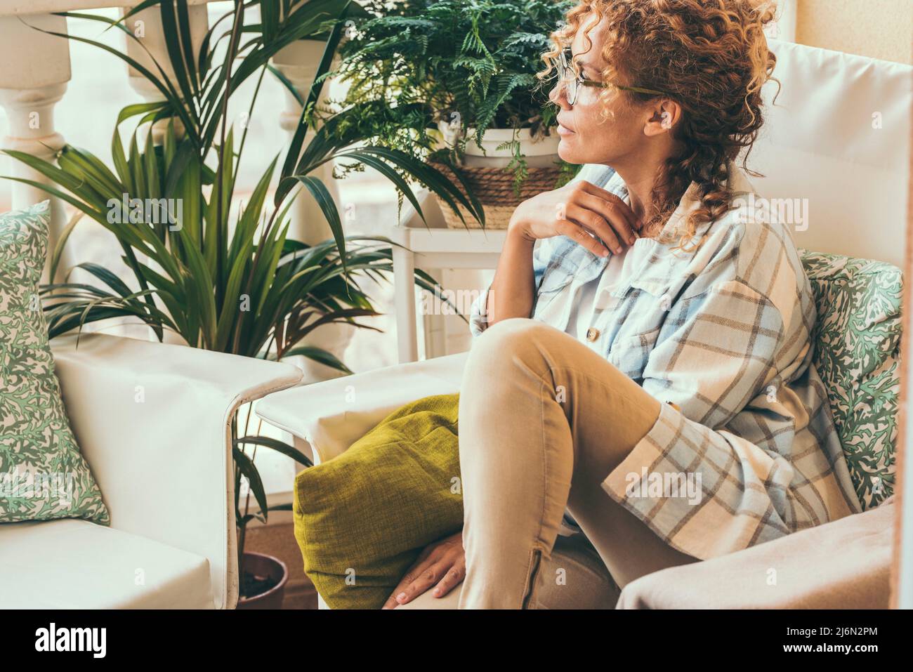 Woman sitting on chair outside hi-res stock photography and images - Alamy