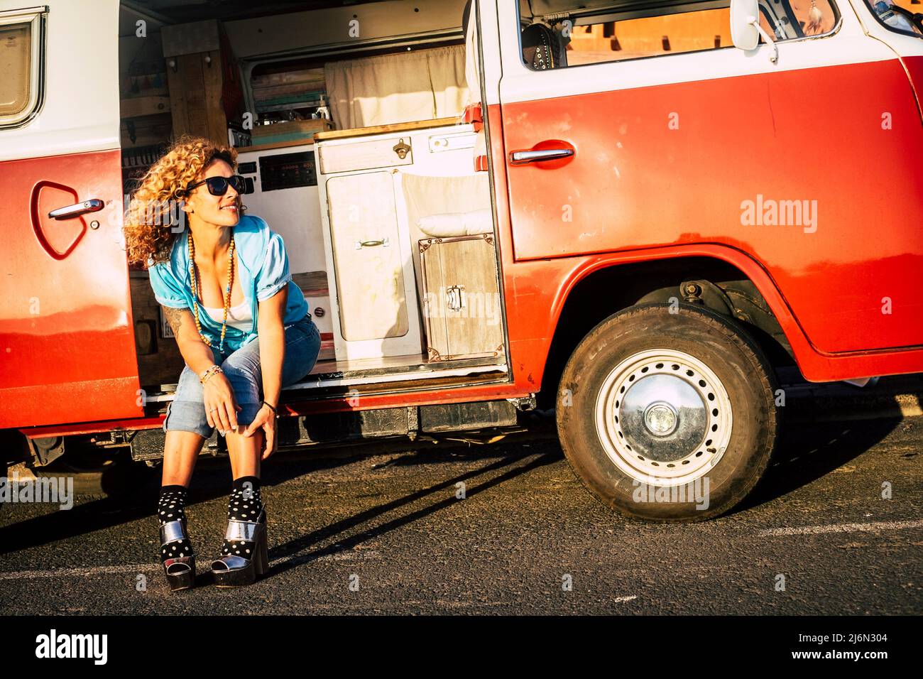 Attractive young woman enjoy travel with old stylish red van - female ...