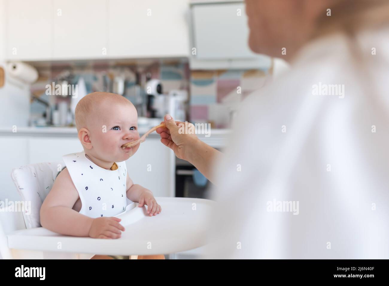 baby's first feeding, mom feeds a baby with a spoon Stock Photo - Alamy