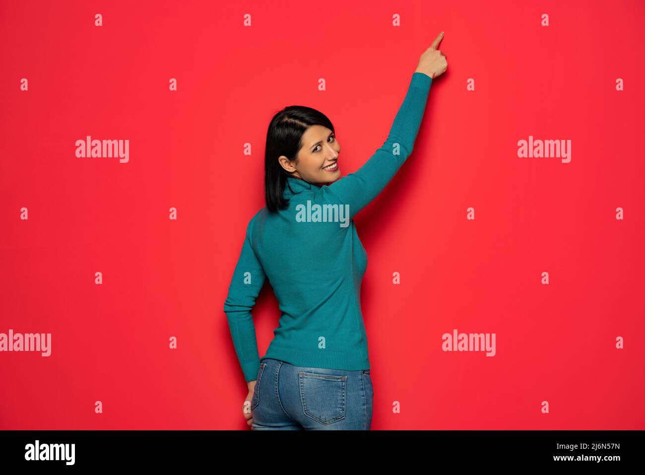 Portrait brunette woman pointing behind hi-res stock photography and ...