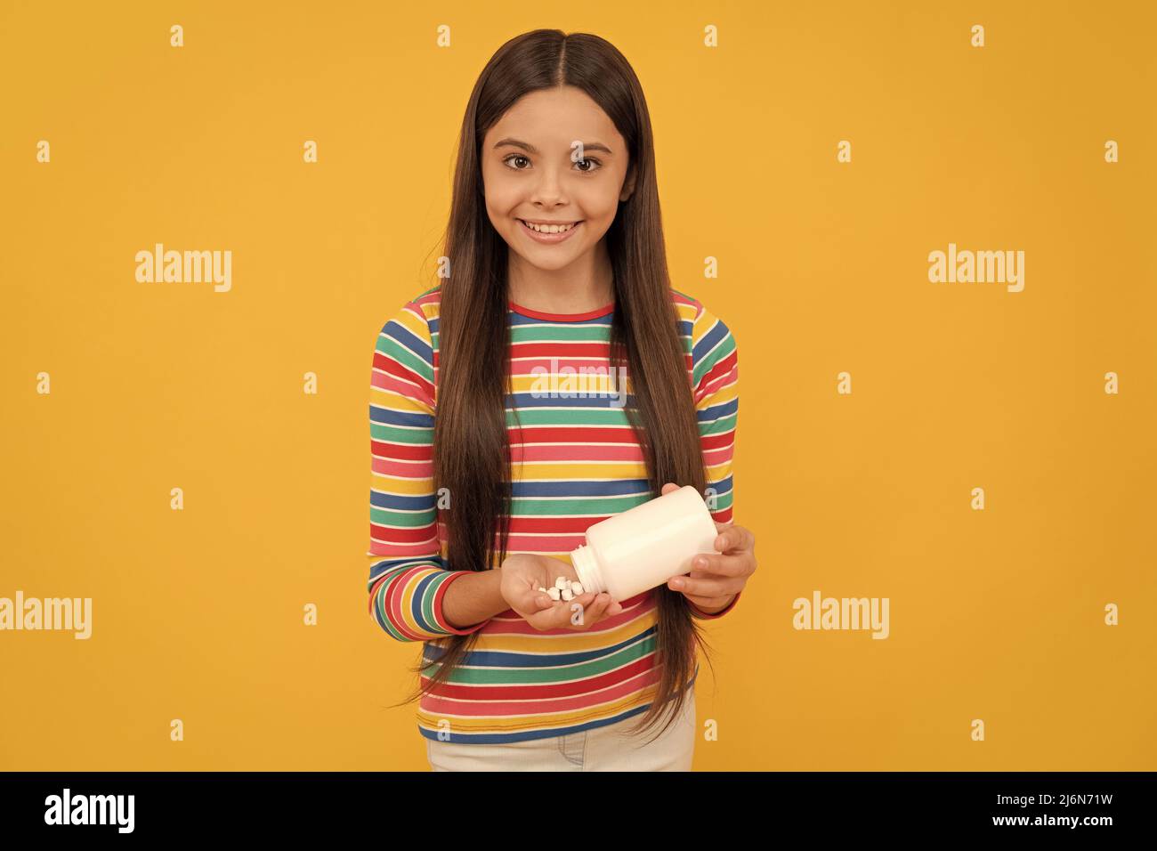 capsule shape tablet for kids. girl hold multivitamin. healthy ...