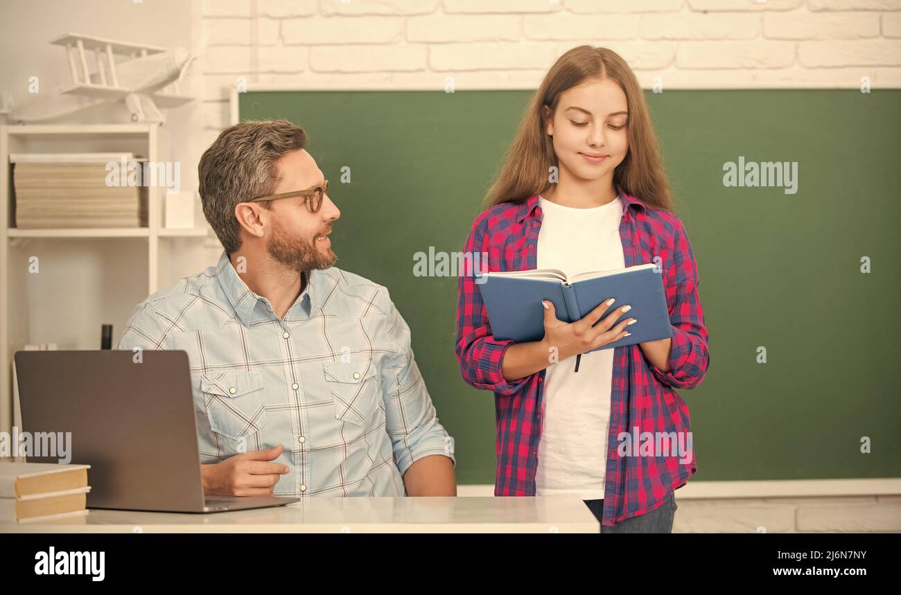 dad and daughter use notebook. back to school. childhood education ...