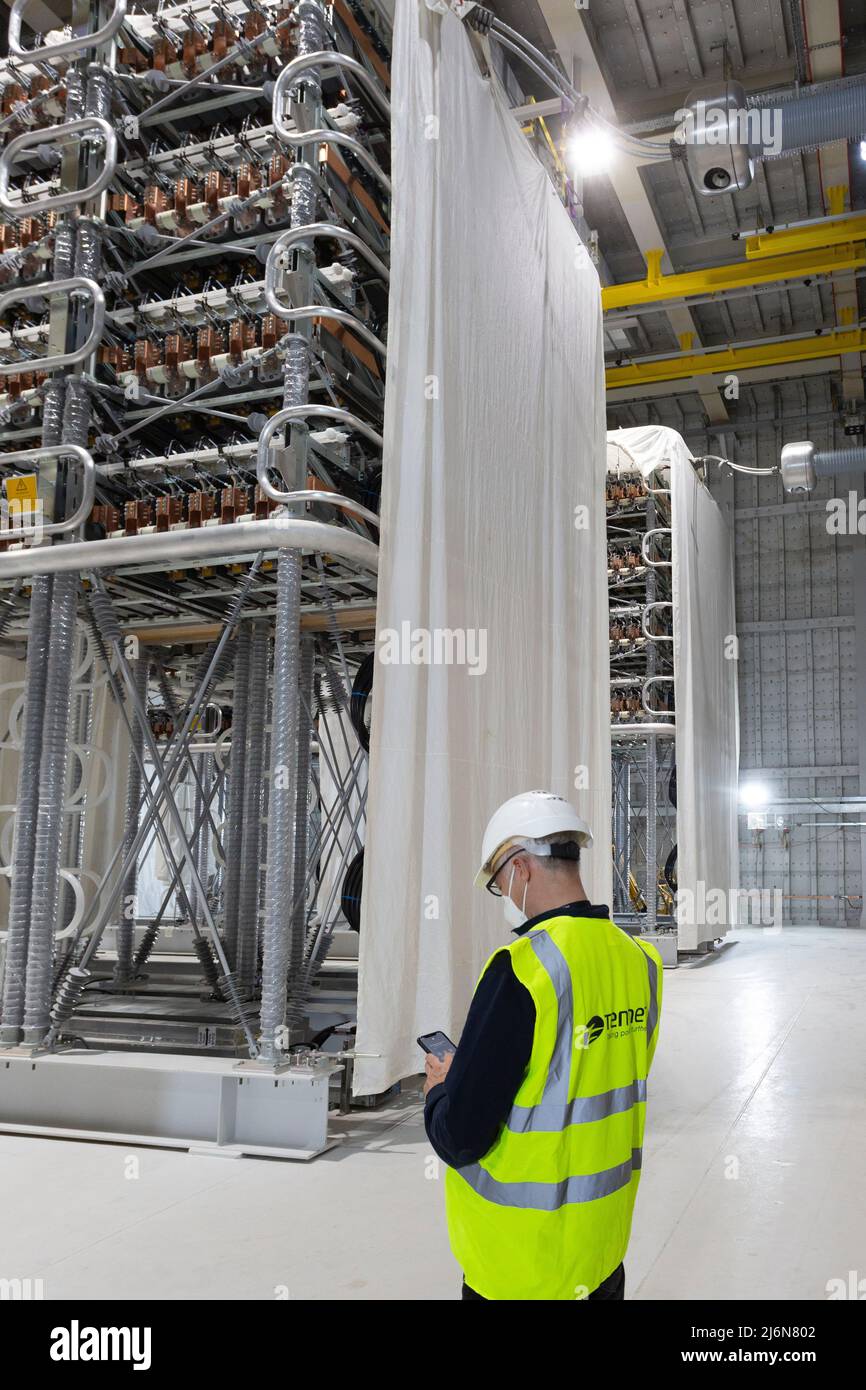 PRODUCTION - 25 April 2022, Spain, Cadiz: A Tennet employee stands in ...