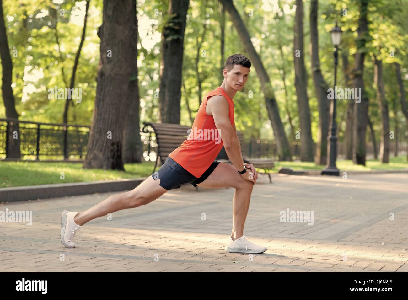 Warming up before workout. Fit guy hold lunge position. Man do warm-up ...