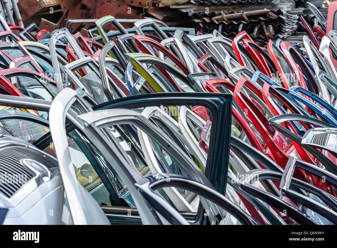 different colored car doors at a car junkyard Stock Photo - Alamy