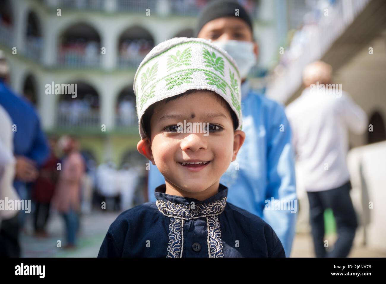 A little boy smiles for a picture during Eid al-Fitr prayers at ...