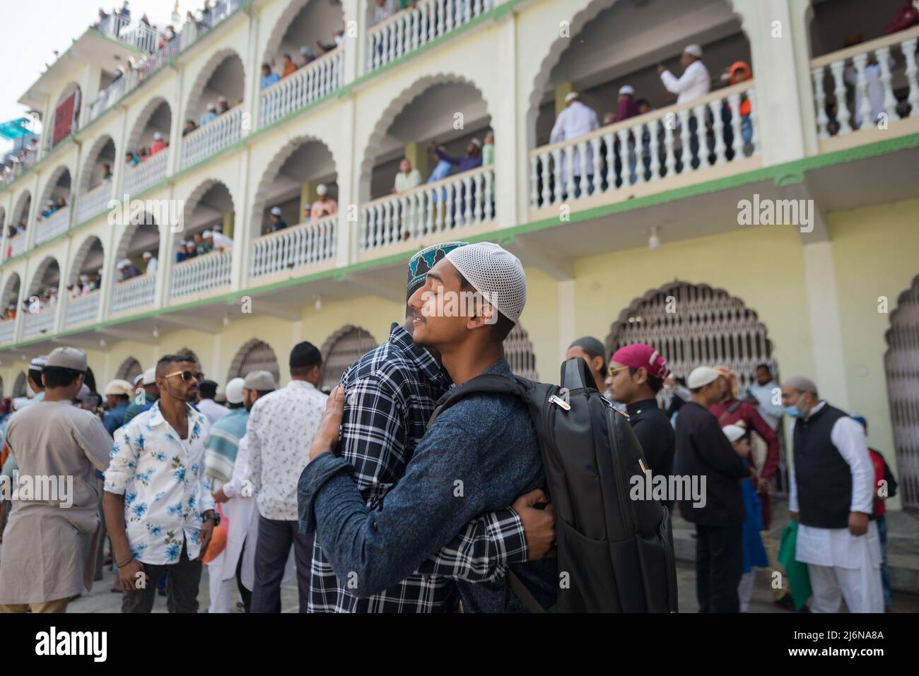 Muslim devotees greet each other after offering special morning prayer ...
