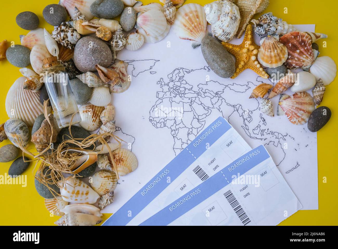 World map, seashells and pebbles boarding pass. Travel vacation concept ...