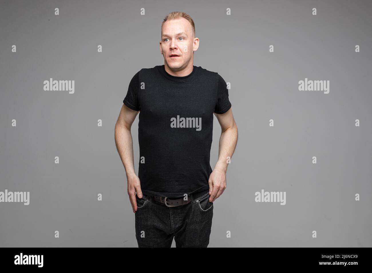 adult emotional caucasian man with short fair hair sigh and looks aside ...