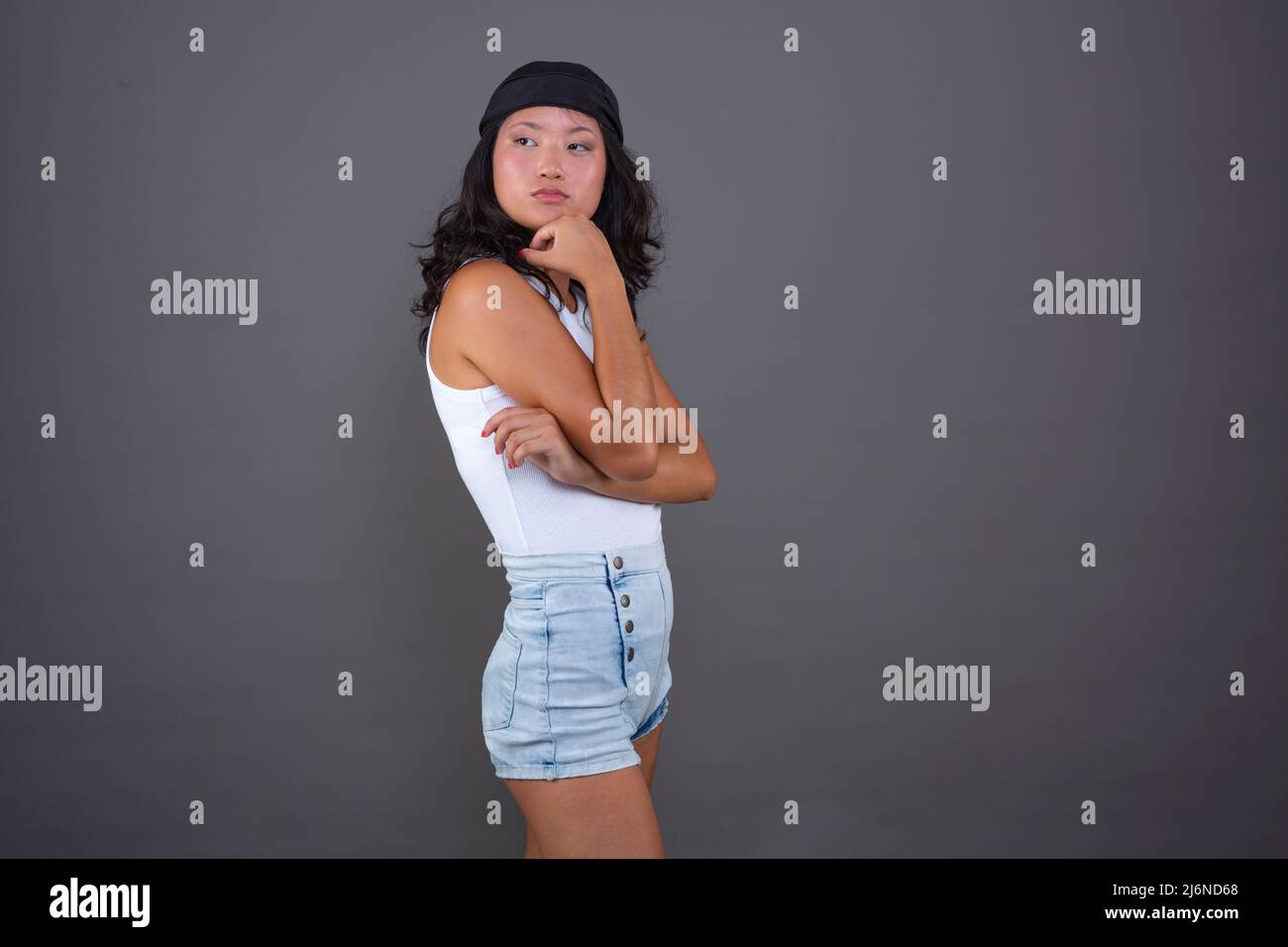 young woman of asian ethnicity in urban and defiant attire Stock Photo ...